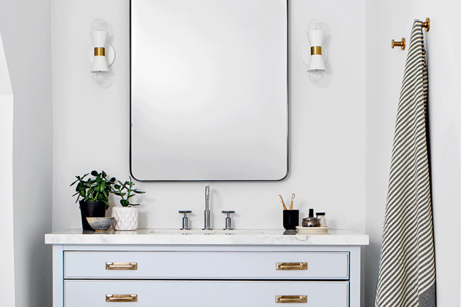 A powder blue vanity and mermaid-inspired tiles give a bathroom a ...